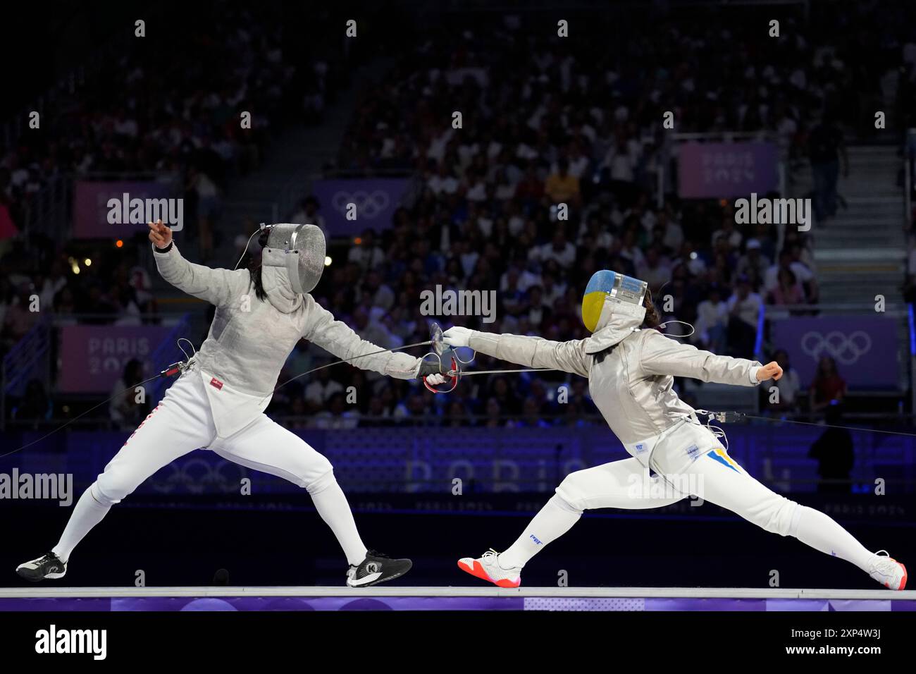 South Korea's Choi Sebin, left, competes with Ukraine's Alina ...