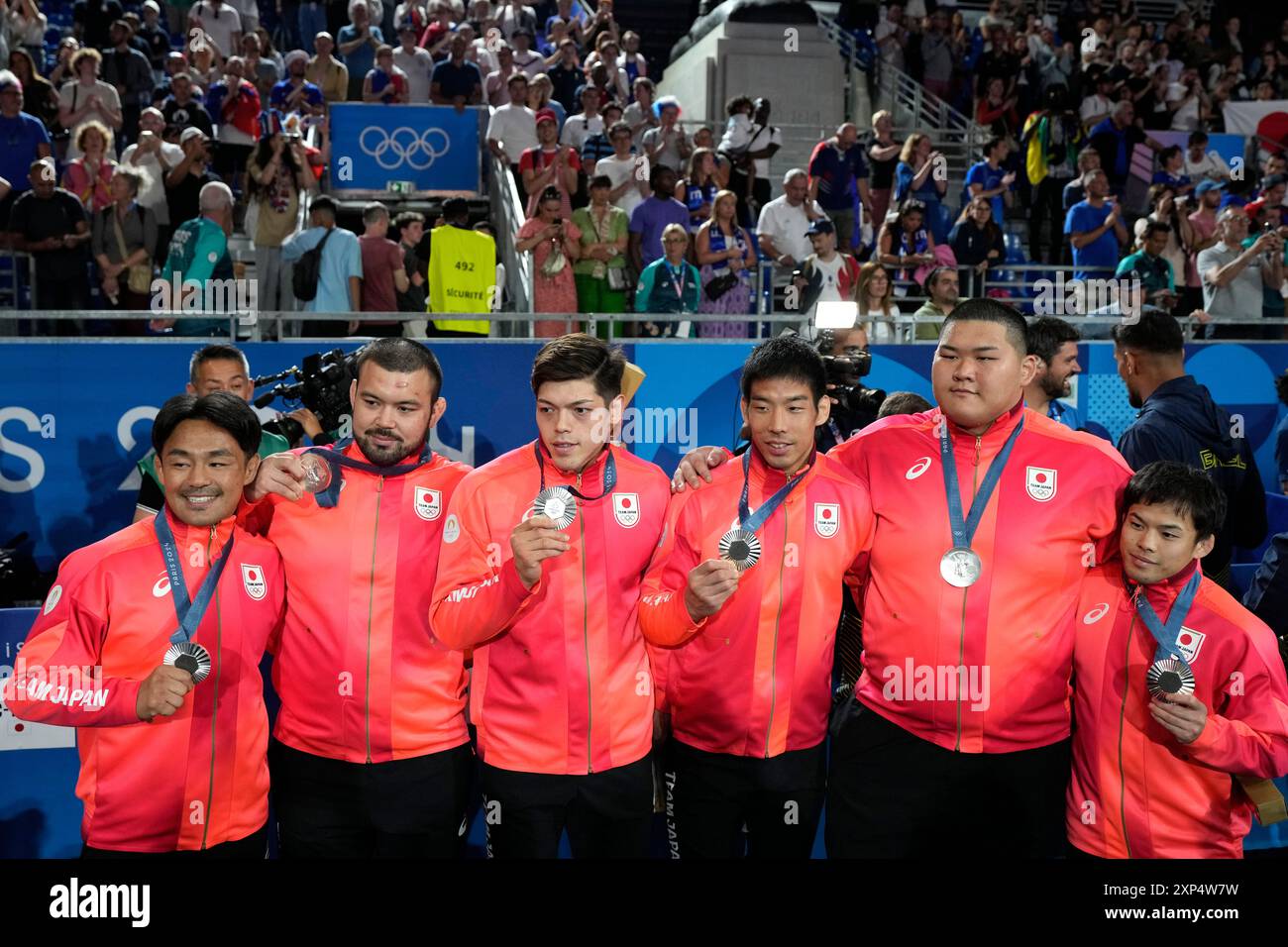 Men's team of Japan poses for photographers after the award ceremony of ...
