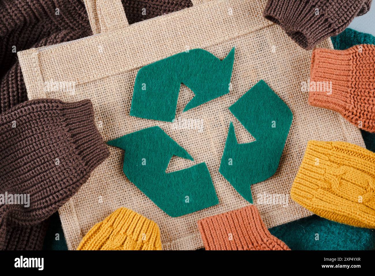 Recycling of clothes. Green recycling sign on a shopping bag with ...