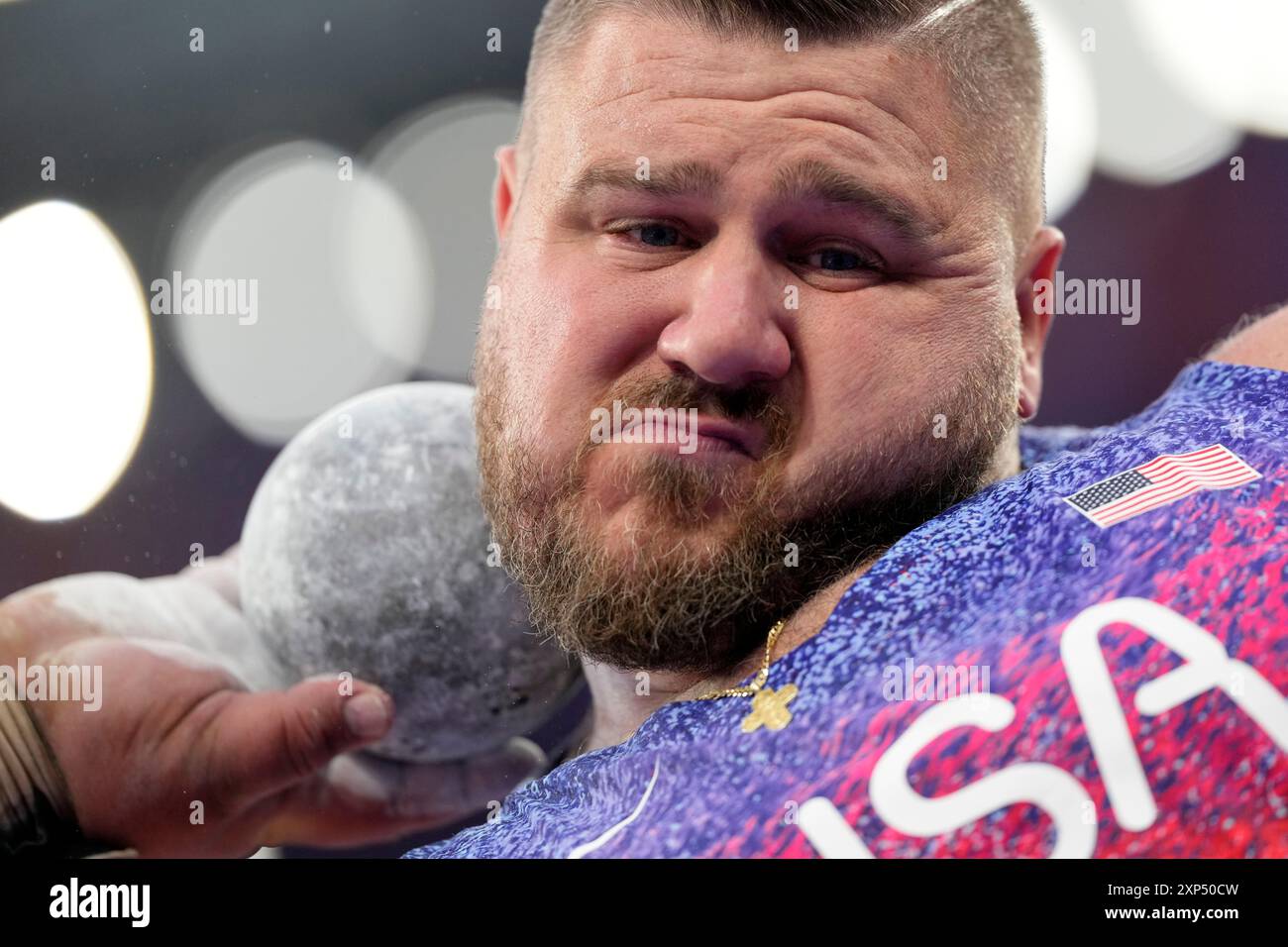 Ryan Crouser, of the United States, competes in the men's shot put ...
