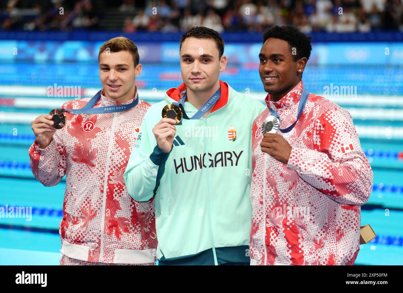 Hungary's Kristof Milak (centre) with the gold medal, alongside Canada ...