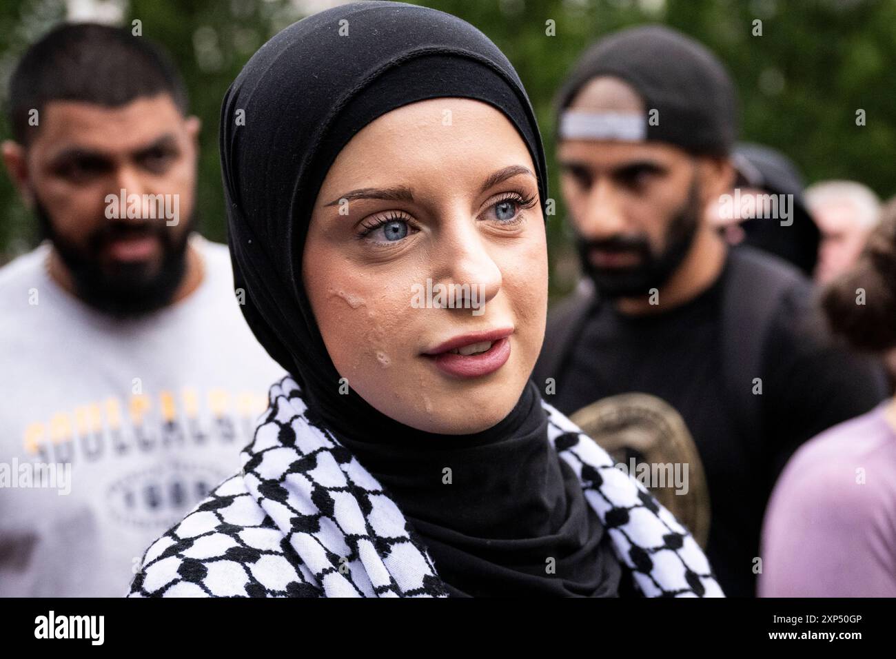 Manchester, 3rd August 2024. A young Muslim woman has spit on her face ...