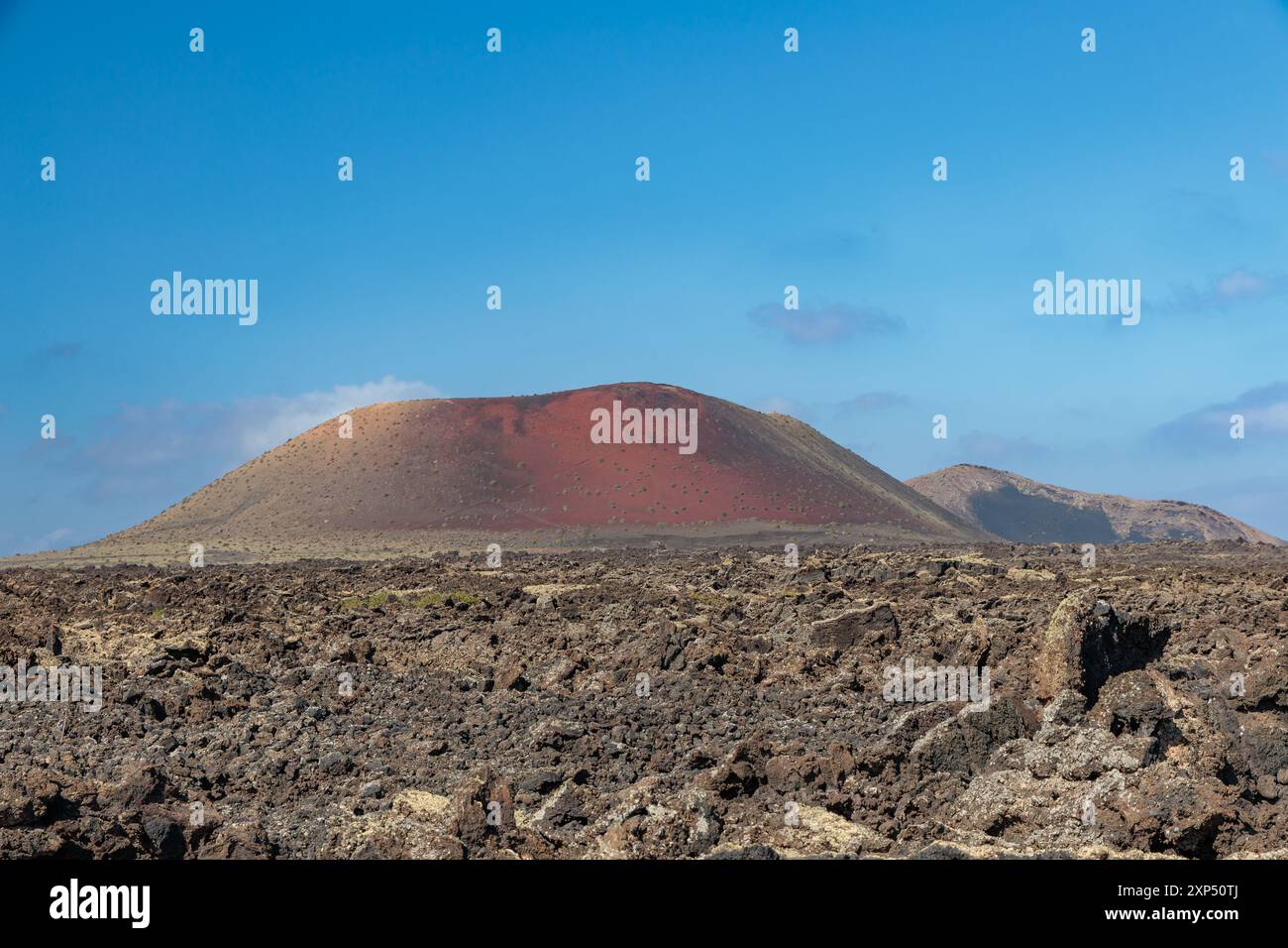 Typical Lanzarote landscape with an extinct volcano in the background ...