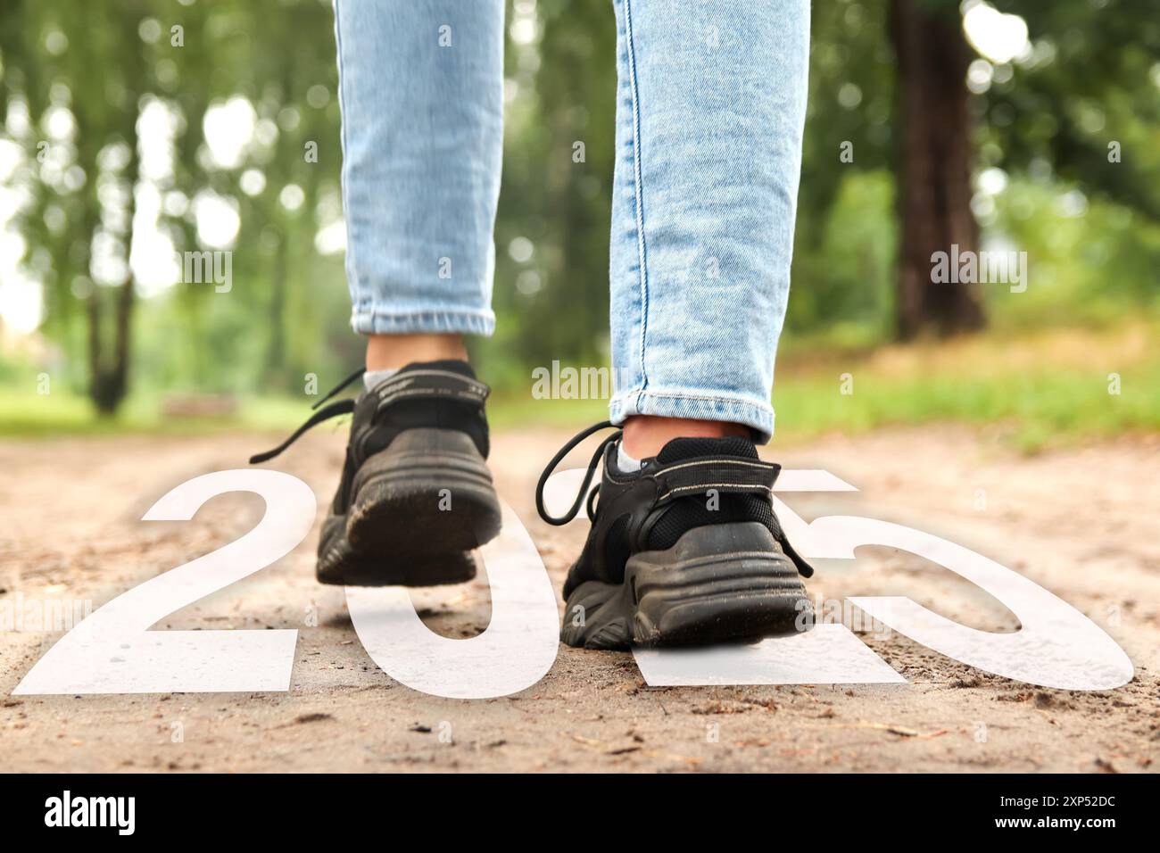2025 New Year step forward in a forest, people walking towards future ...