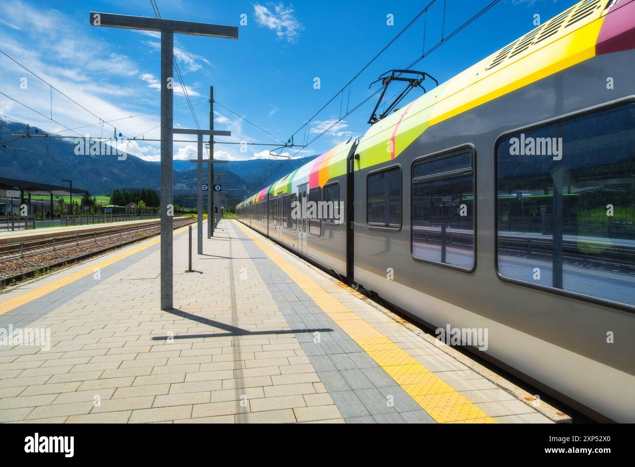 High-speed green passenger train at railway station platform Stock ...