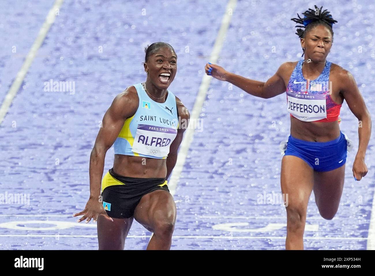Julien Alfred, of Saint Lucia, crosses the finish line ahead of Melissa ...