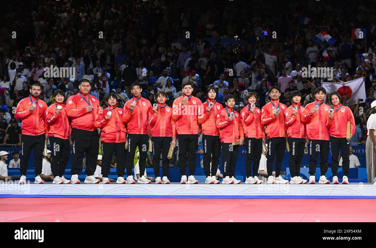 Japan team members pose during the medal ceremony after winning silver ...