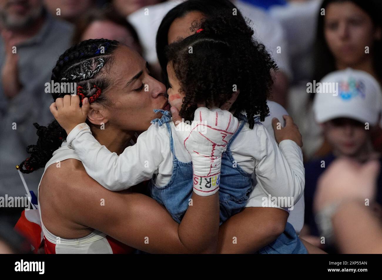 France's Wassila Lkhadiri, kisses a kid after she was defeated by ...
