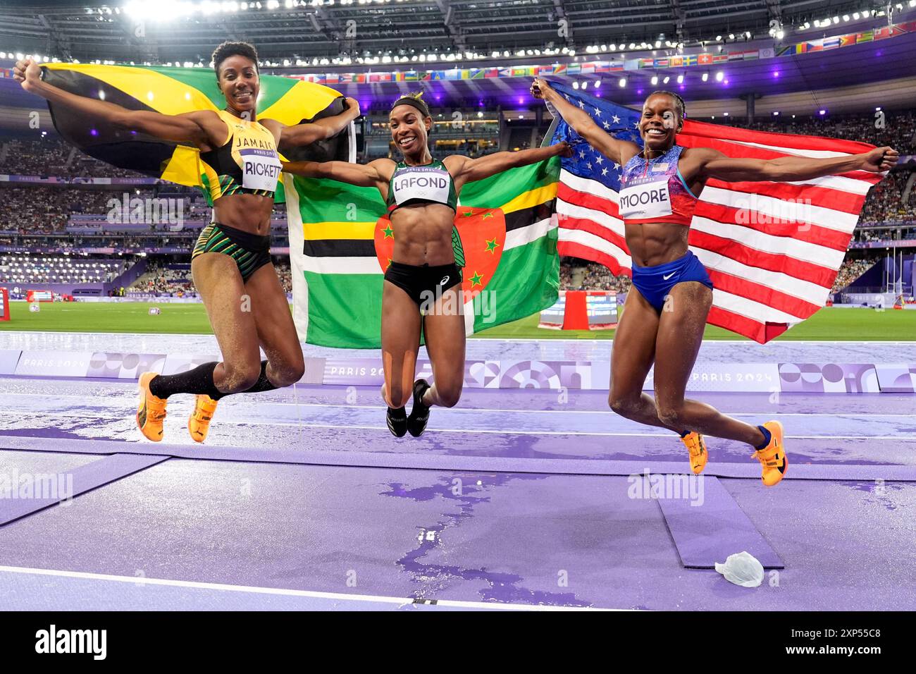 Women's triple jump winner Thea Lafond, centre, of Dominica, celebrates ...