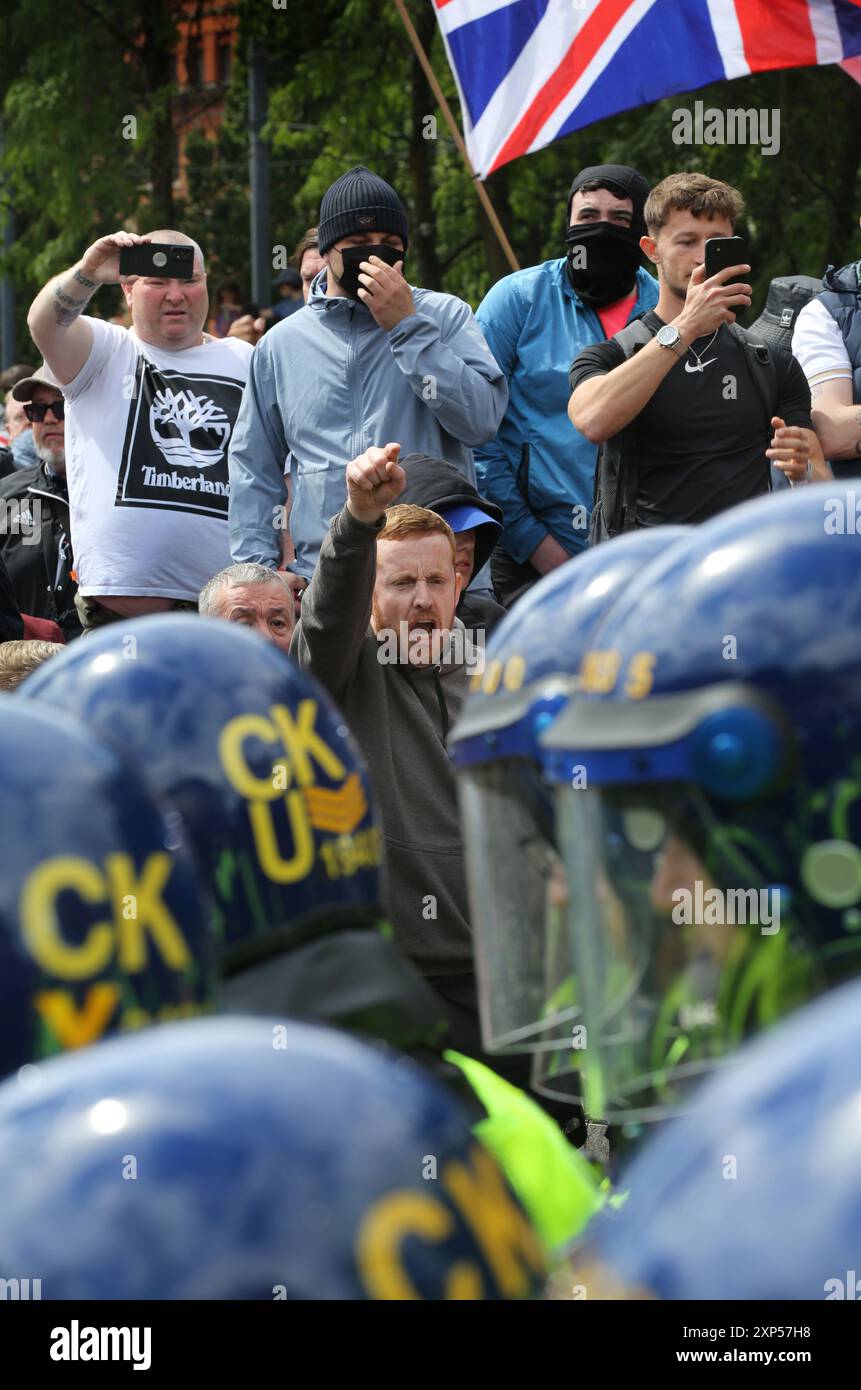Manchester, England, UK. 3rd Aug, 2024. A nationalist protester taunts ...