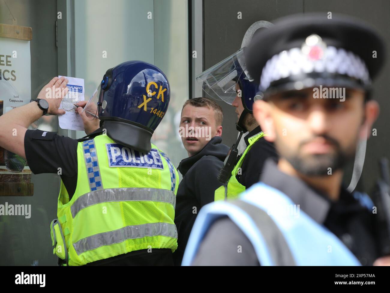 Manchester, England, UK. 3rd Aug, 2024. A supporter of stricter ...