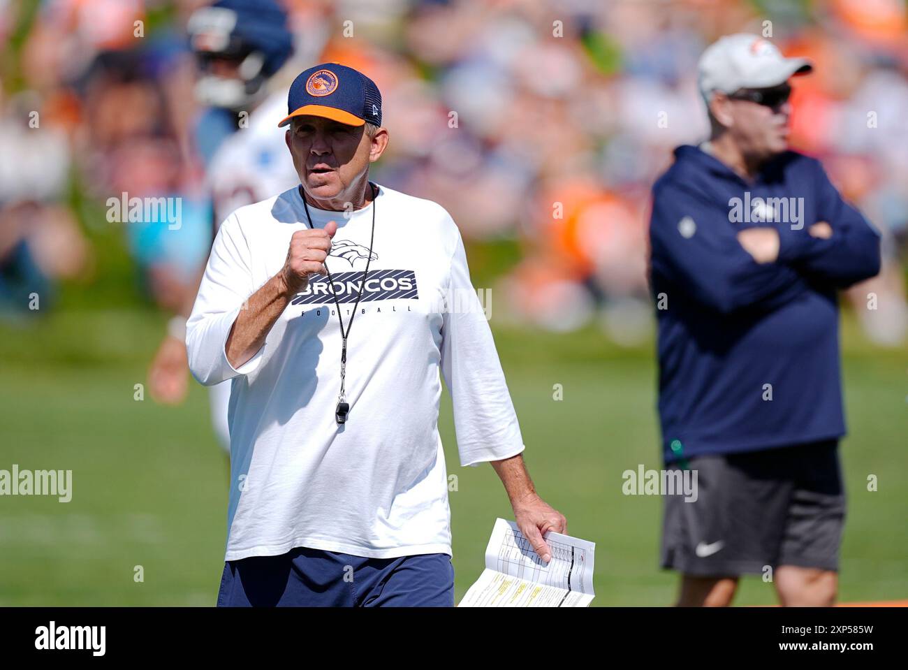 Denver Broncos head coach Sean Payton, front, and Paul Kelly, assistant ...