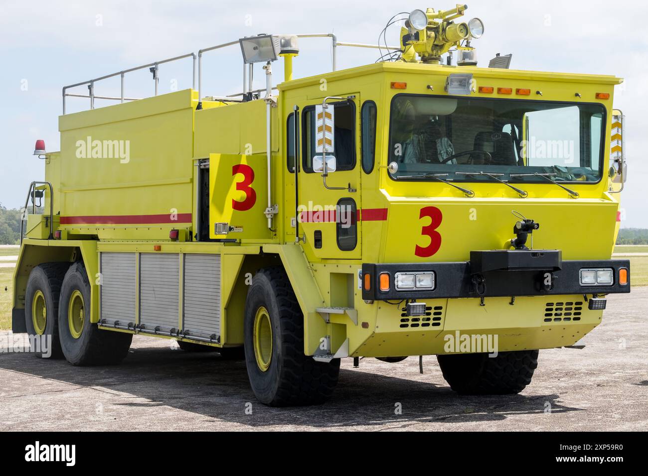 Large yellow airport fire truck with number three parked on the tarmac ...