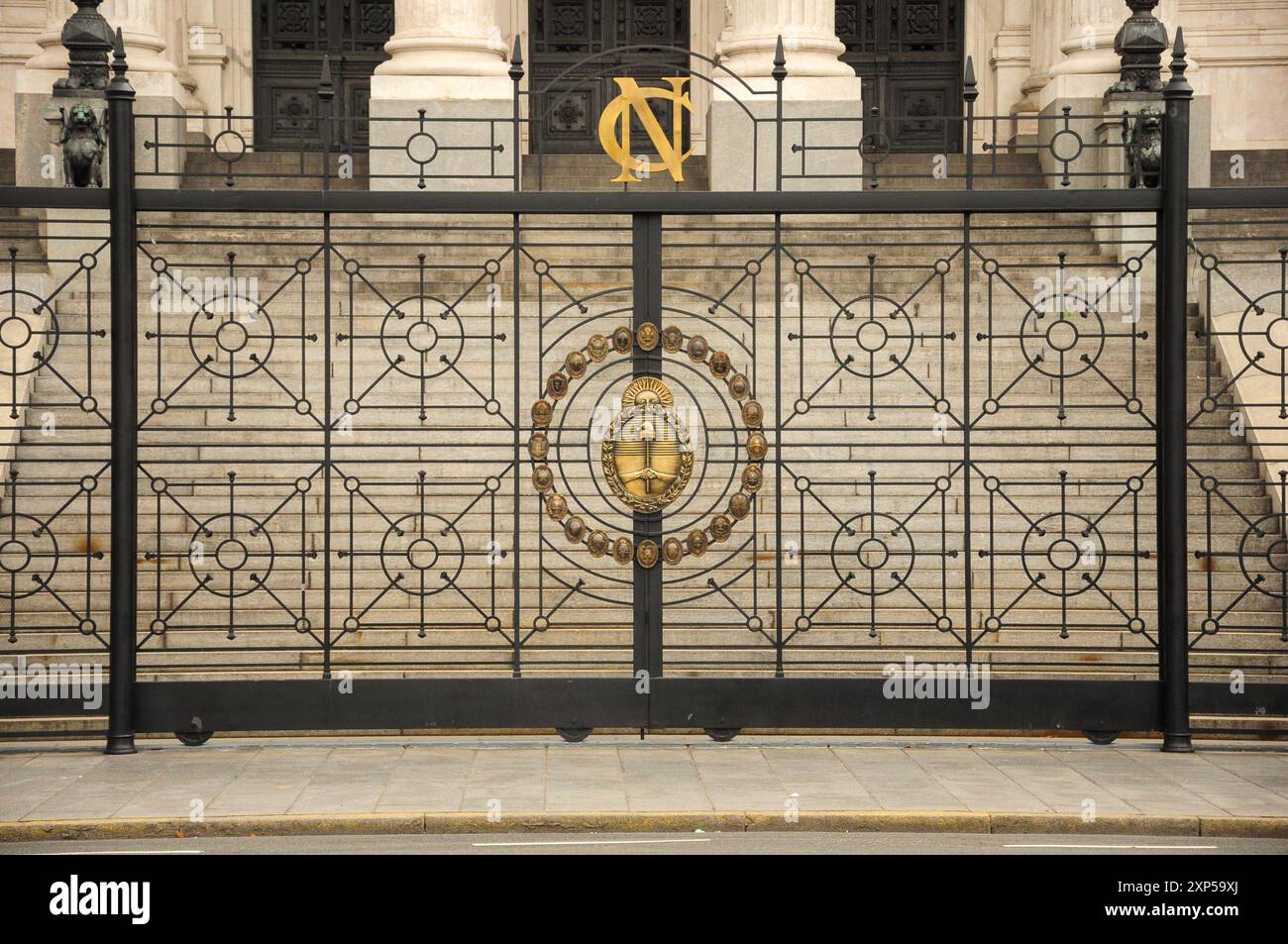 Ornate gate and grand steps of historic building with intricate emblem ...