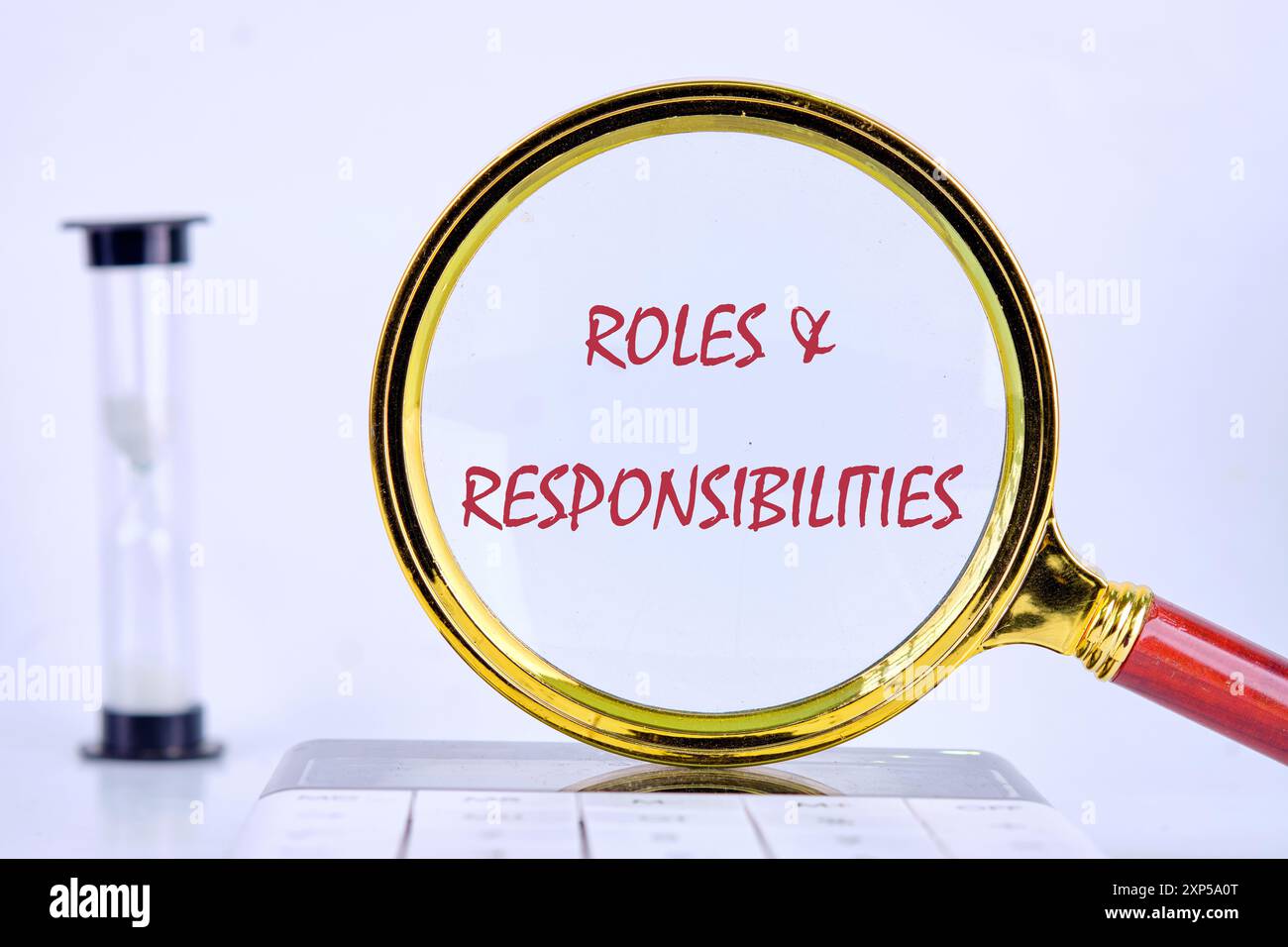 ROLES and RESPONSIBILITIES text written through a magnifying glass on a ...