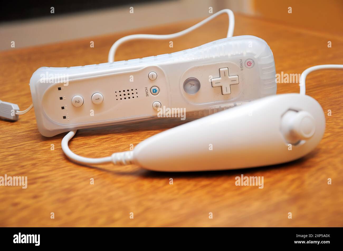 White gaming controller with nunchuck on a wooden table Stock Photo - Alamy