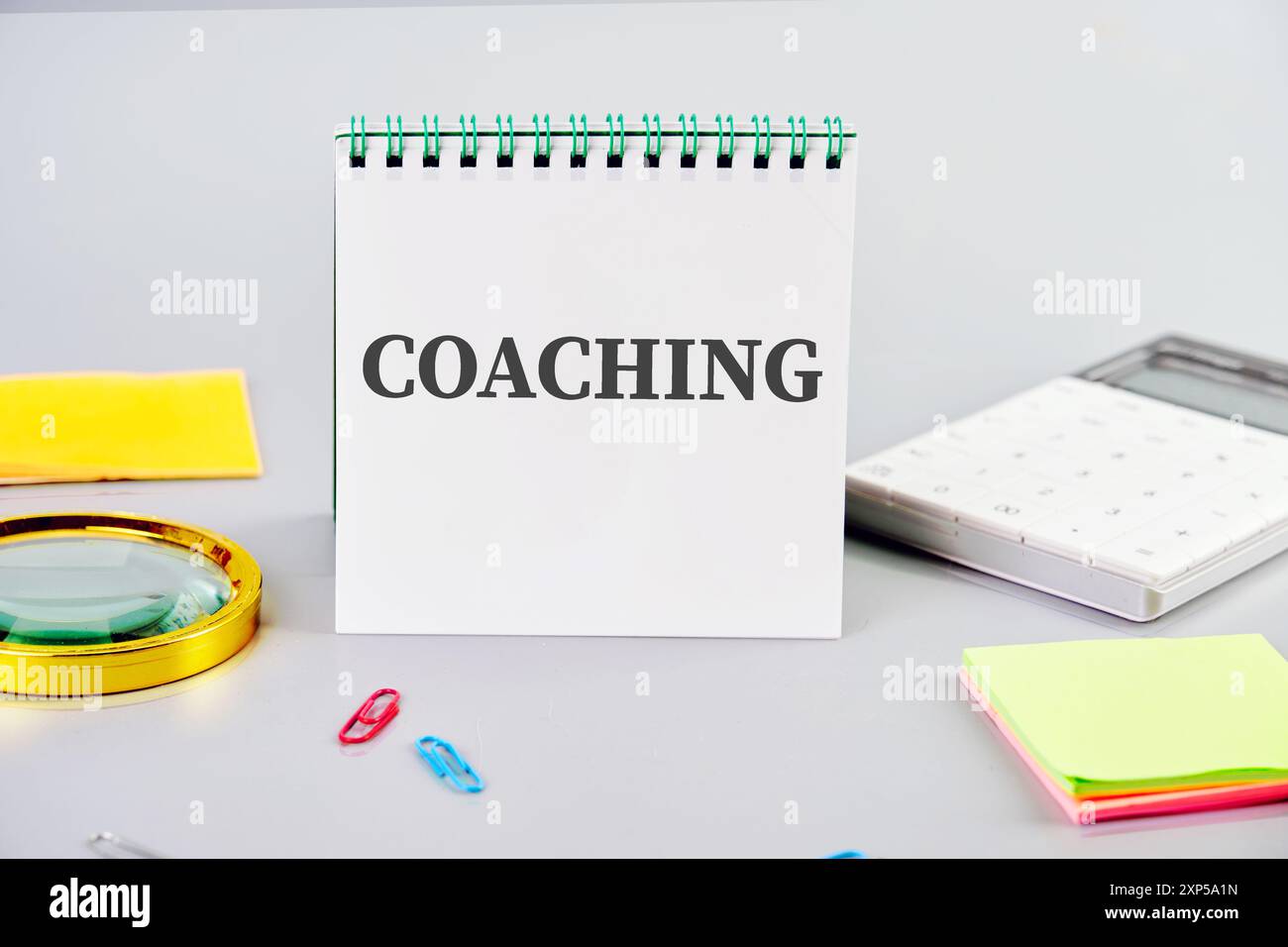 Coaching and Mentoring Concept. COACHING written on a blank piece of notepad Stock Photo - Alamy