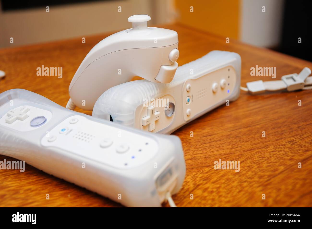 White Gaming Controllers on Wooden Table Ready for Fun Stock Photo - Alamy
