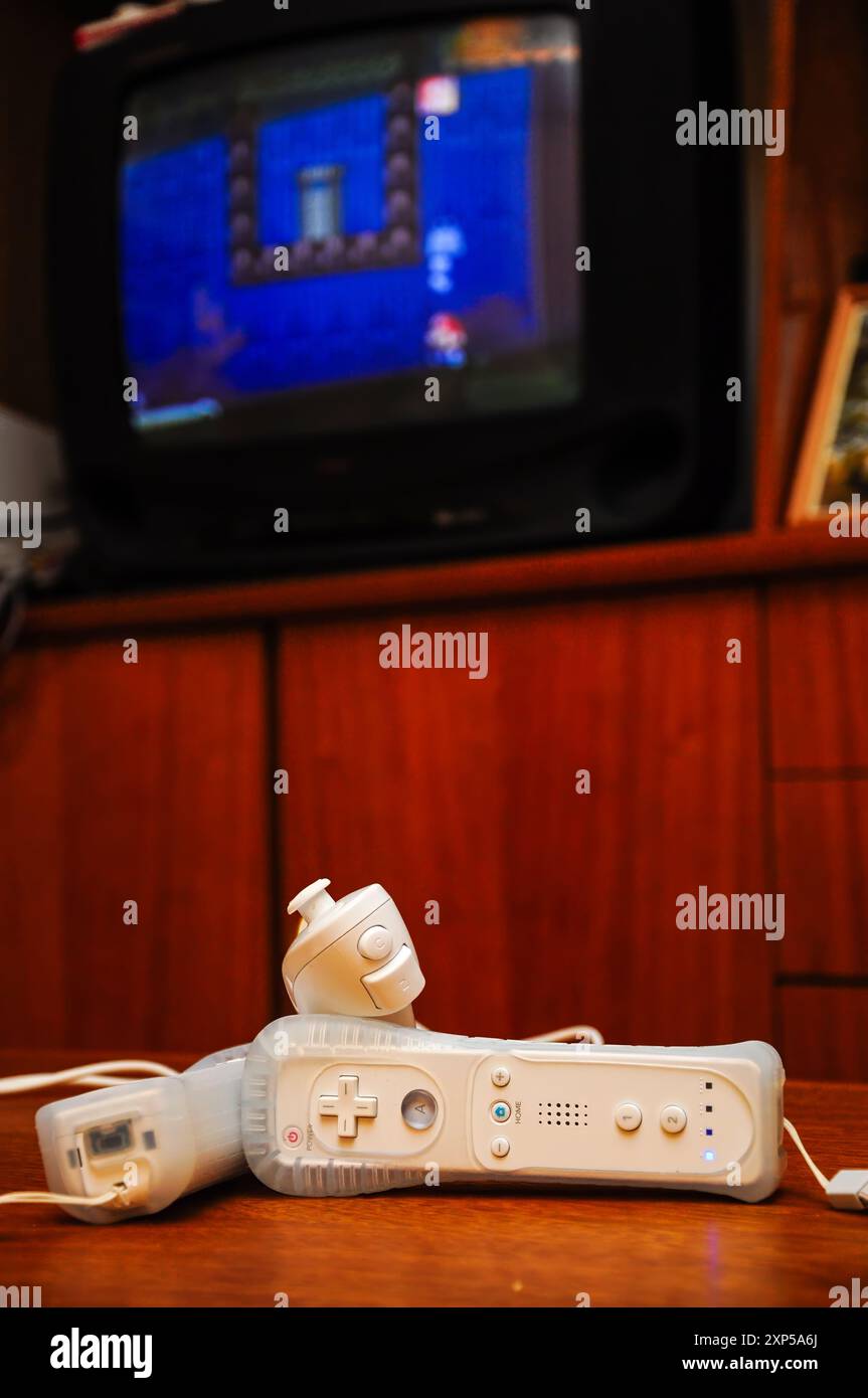 Retro gaming setup with CRT TV and classic game console controllers ...