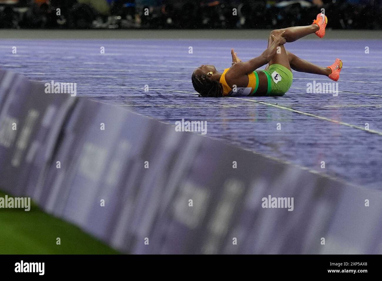 Marie-Josee Ta Lou-Smith, of Ivory Coast, clutches her leg after ...