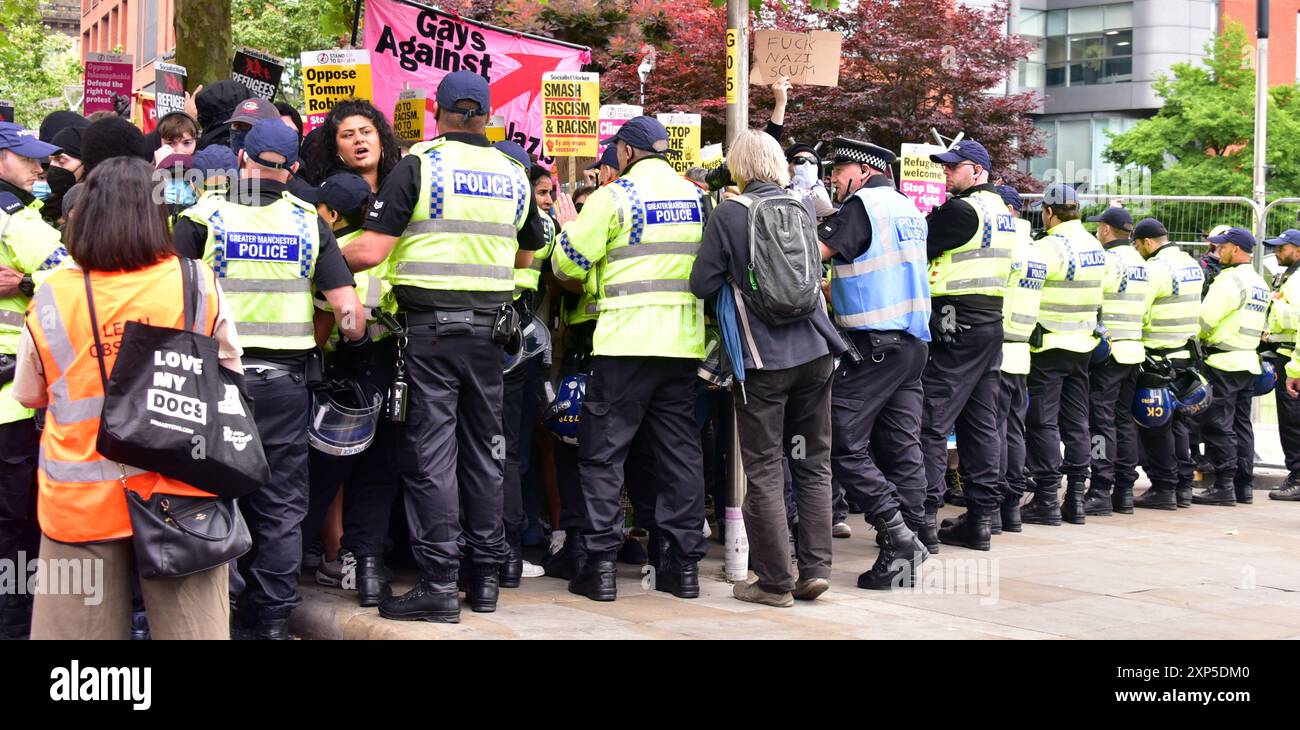 Manchester, UK, 3rd August, 2024. Police officers hem in and control ...