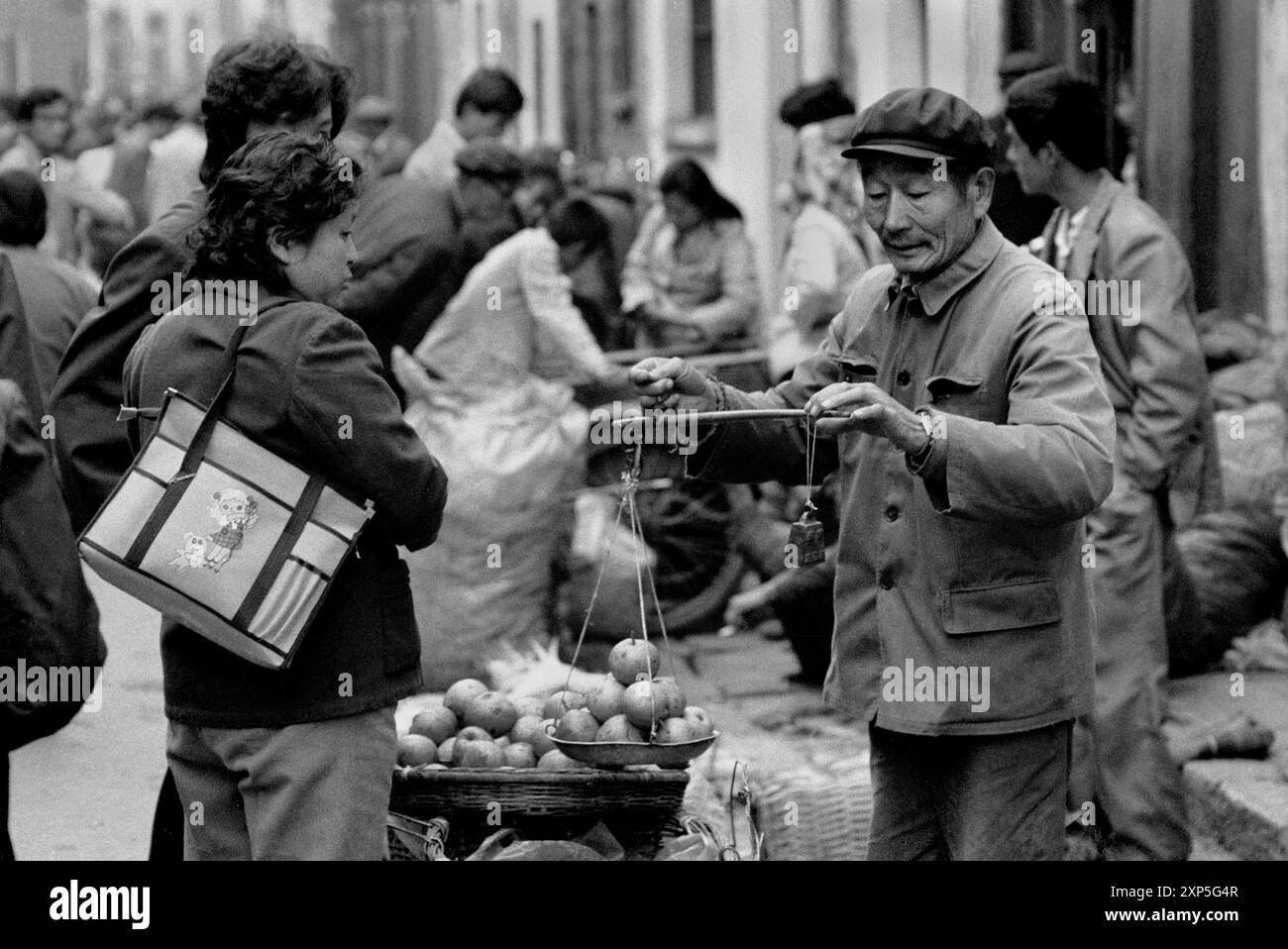 Apple seller wearing a Mao suite in Kunming China before the economic ...