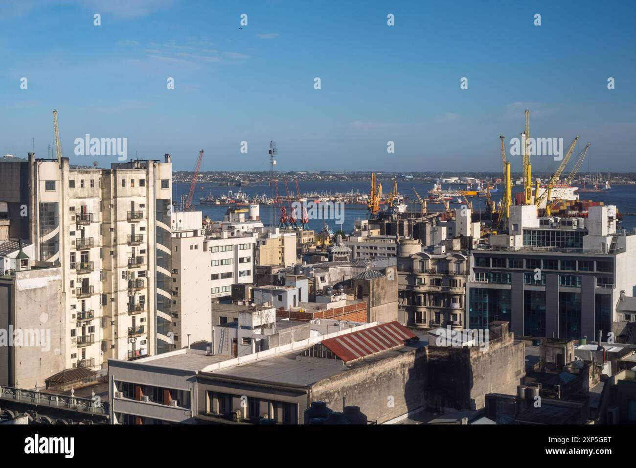 Aerial view of Montevideo's harbor area with numerous cranes and urban ...