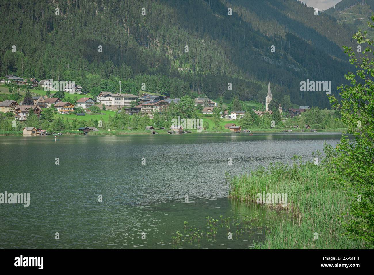 Middle part of weisensee in austria, visible church and typical village ...