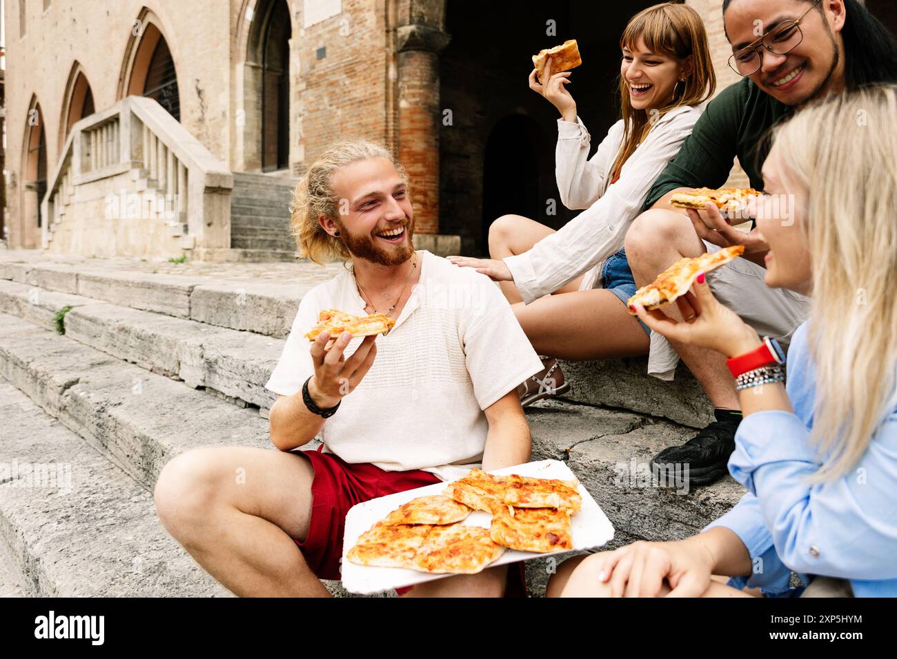 Woman eating pizza outside lunch hi-res stock photography and images ...