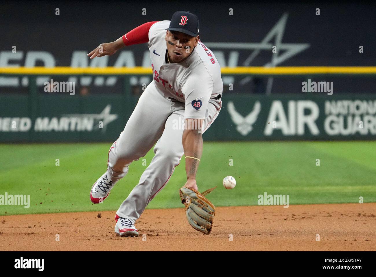 Boston Red Sox third baseman Rafael Devers cannot make the play on an ...