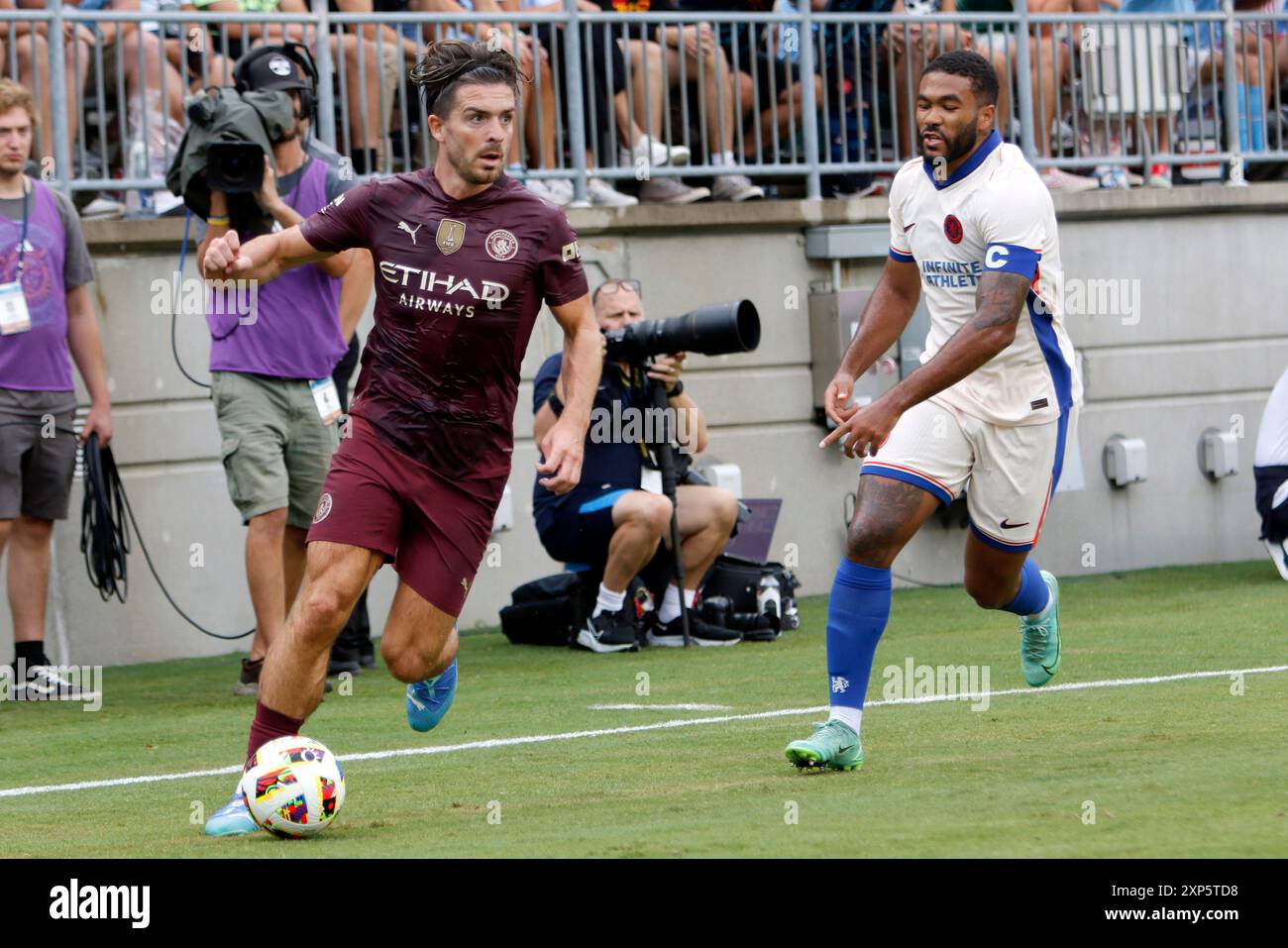 Manchester City's Jack Grealish, left, works the ball past Chelsea's ...