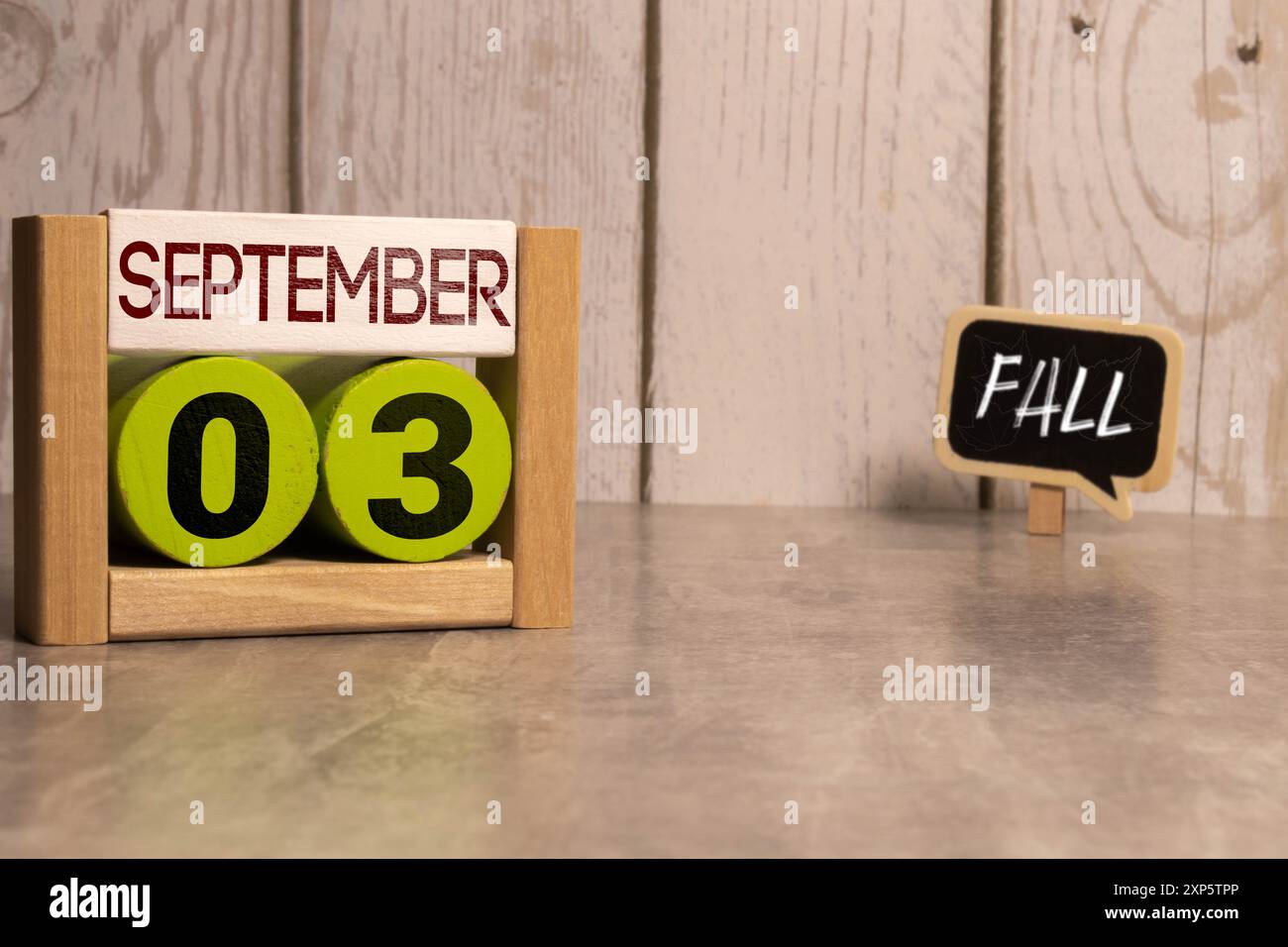 Wooden calendar with the date September 03 and gypsophila flowers on a ...