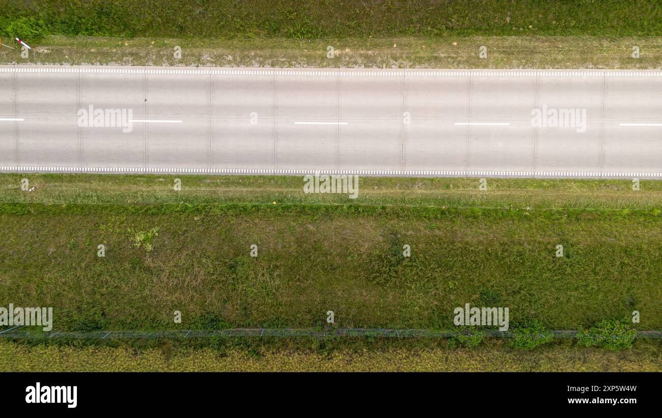 Aerial View of a Straight Rural Road Surrounded by Green Grass and ...