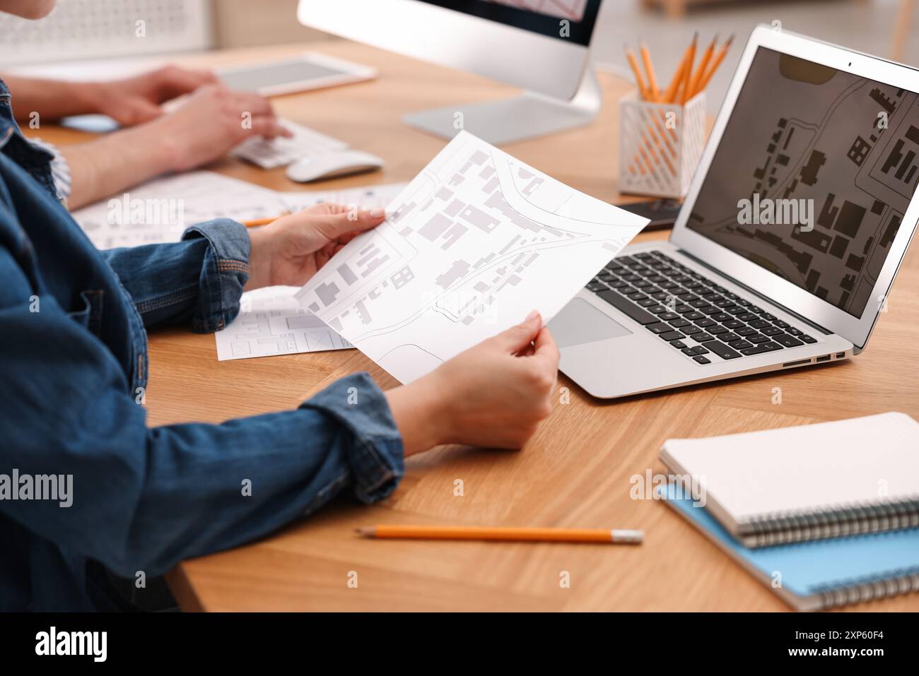 Cartographer working with cadastral map at wooden table, closeup Stock ...