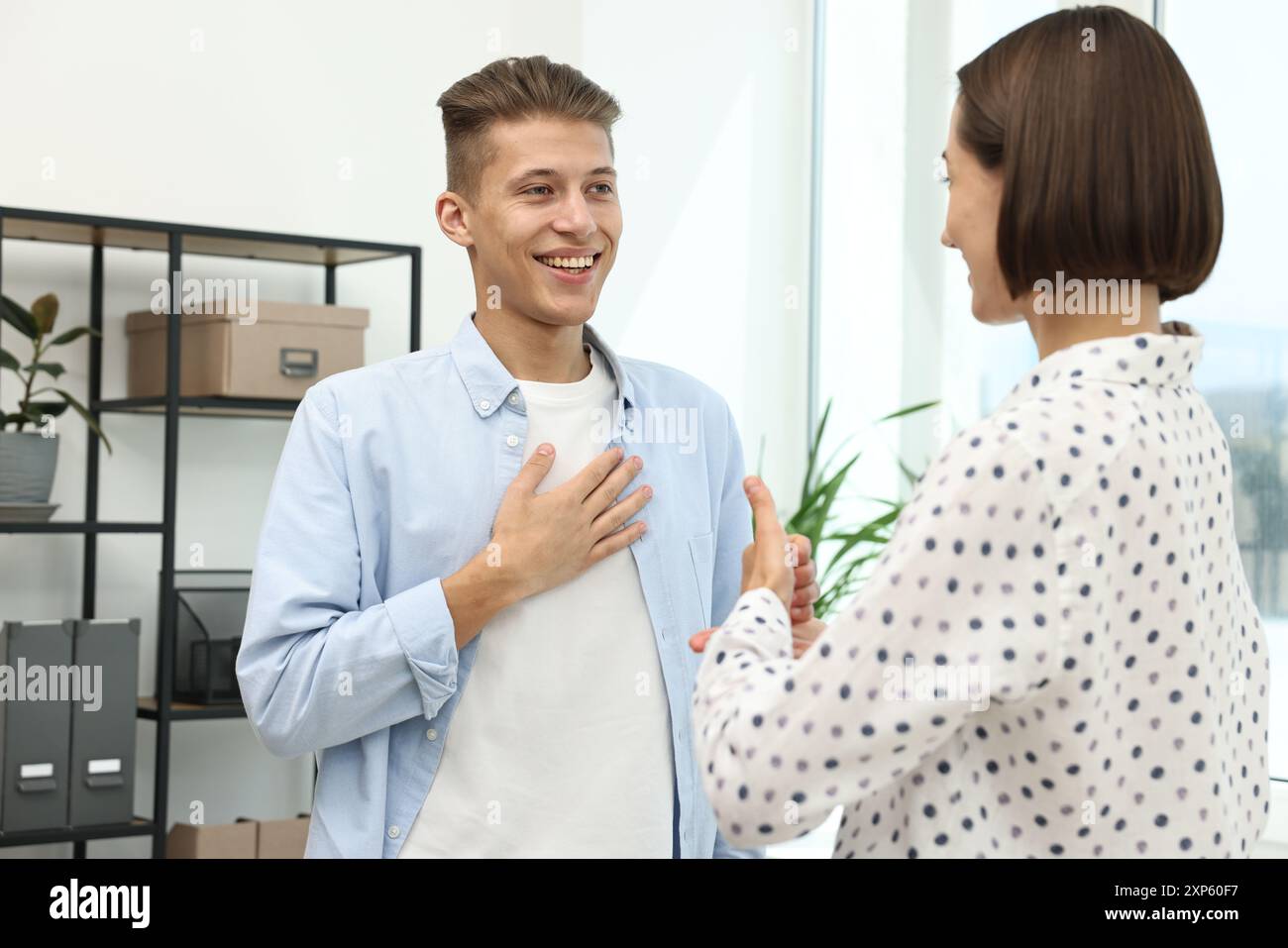 Man and woman using sign language for communication indoors Stock Photo ...