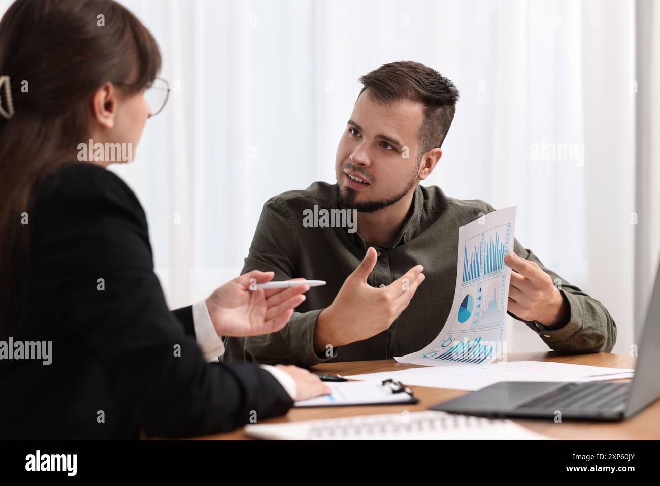 Consultant working with partner at table in office. Business meeting ...