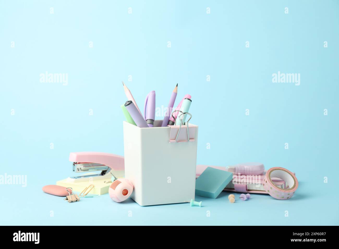 Stapler and other stationery on light blue background Stock Photo - Alamy