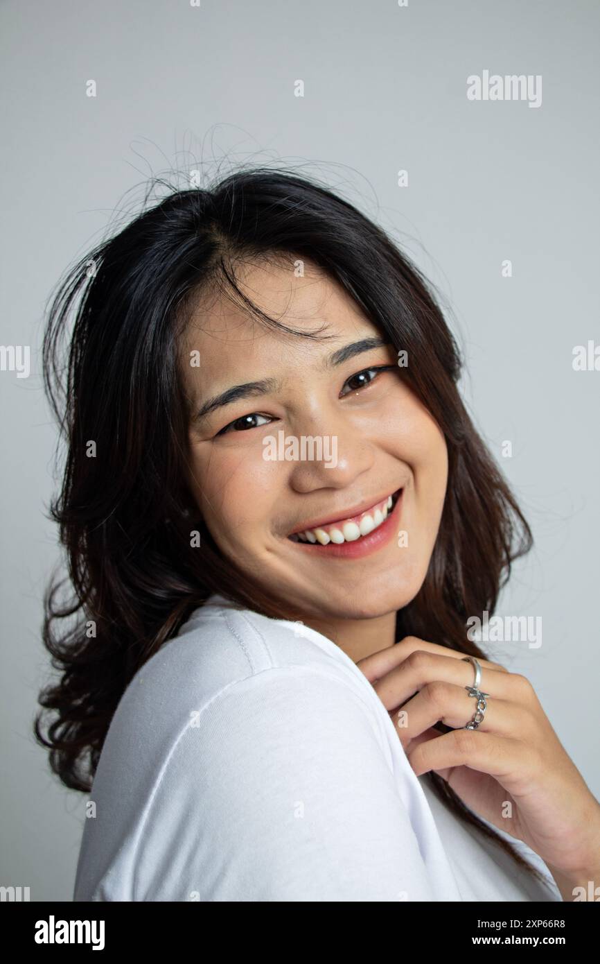 closeup of a young woman with a cheerful smiling pose showing her ...