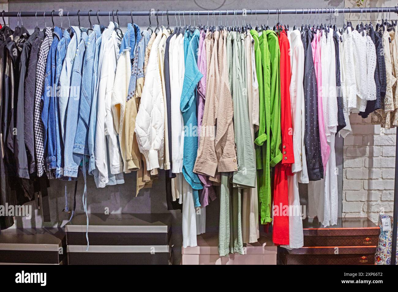 various women's clothing on hangers in the clothing department of a ...