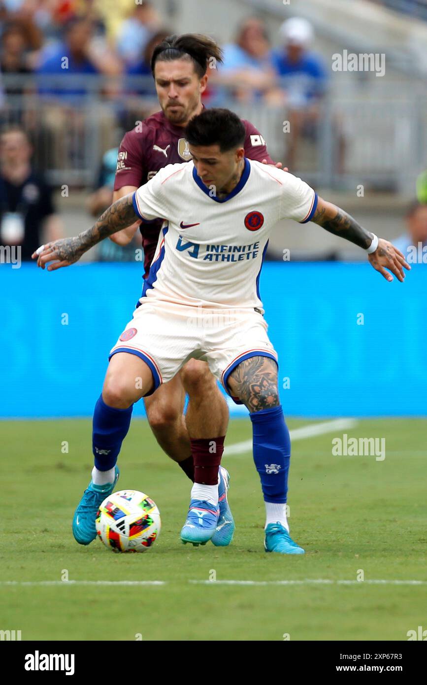 Manchester City's Jack Grealish, rear, defends against Chelsea's Enzo ...