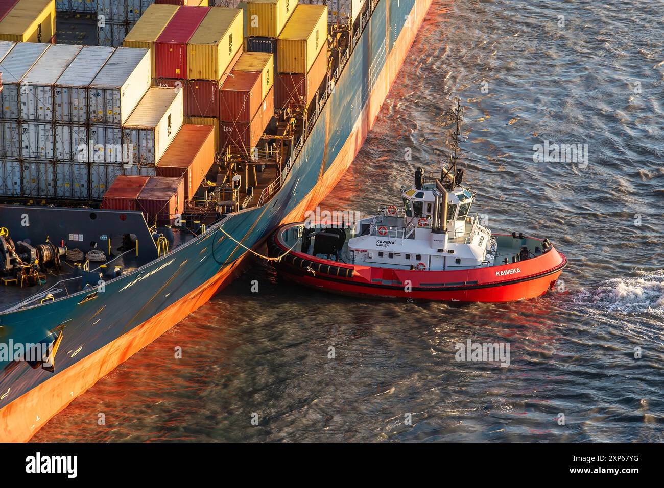 Azimuth-driven tractor tug Kaweka holds the 46,000 tonne container ship ...