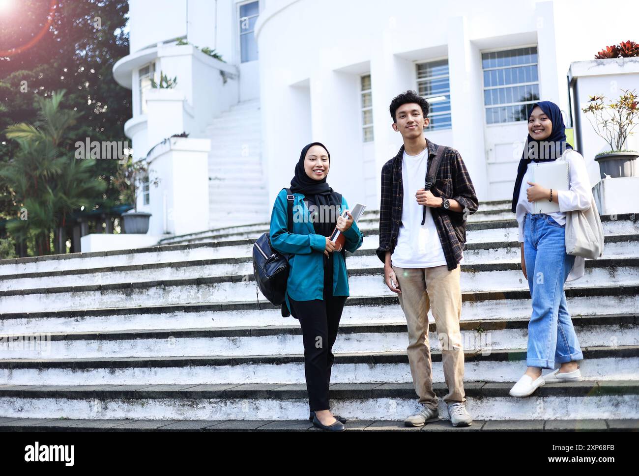 Three Asian Indonesian College Student Pose in Campuss Stairs Stock ...