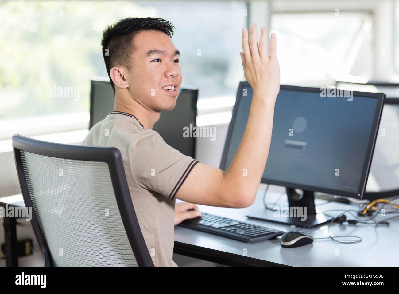 Happy asian boy raising hand hi-res stock photography and images - Alamy