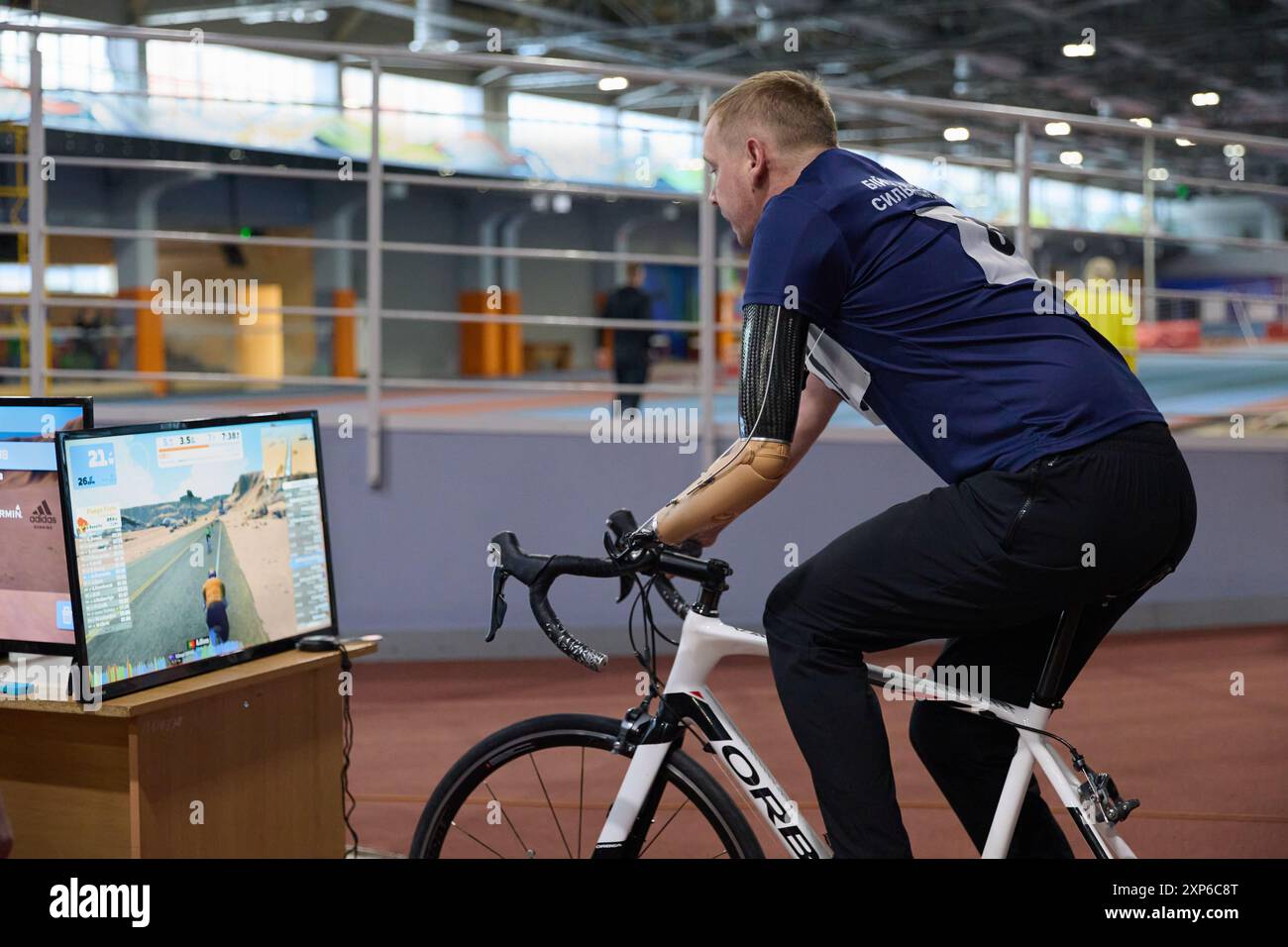 Veteran with amputated limb cycling on a specialized bike trainer stand ...