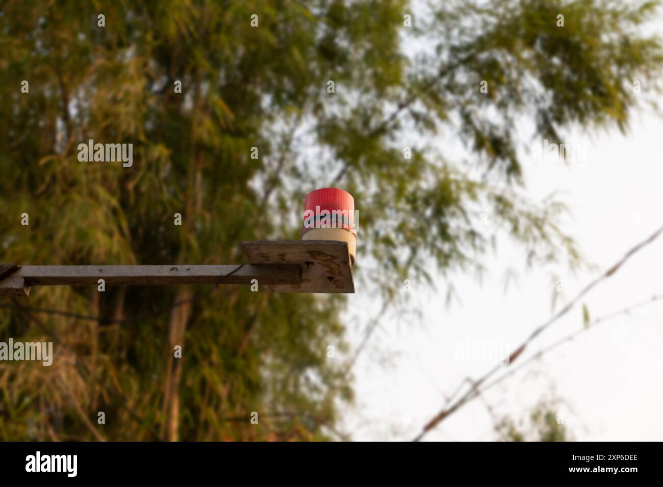 A red and white beacon flashing on a metal pole Stock Photo - Alamy
