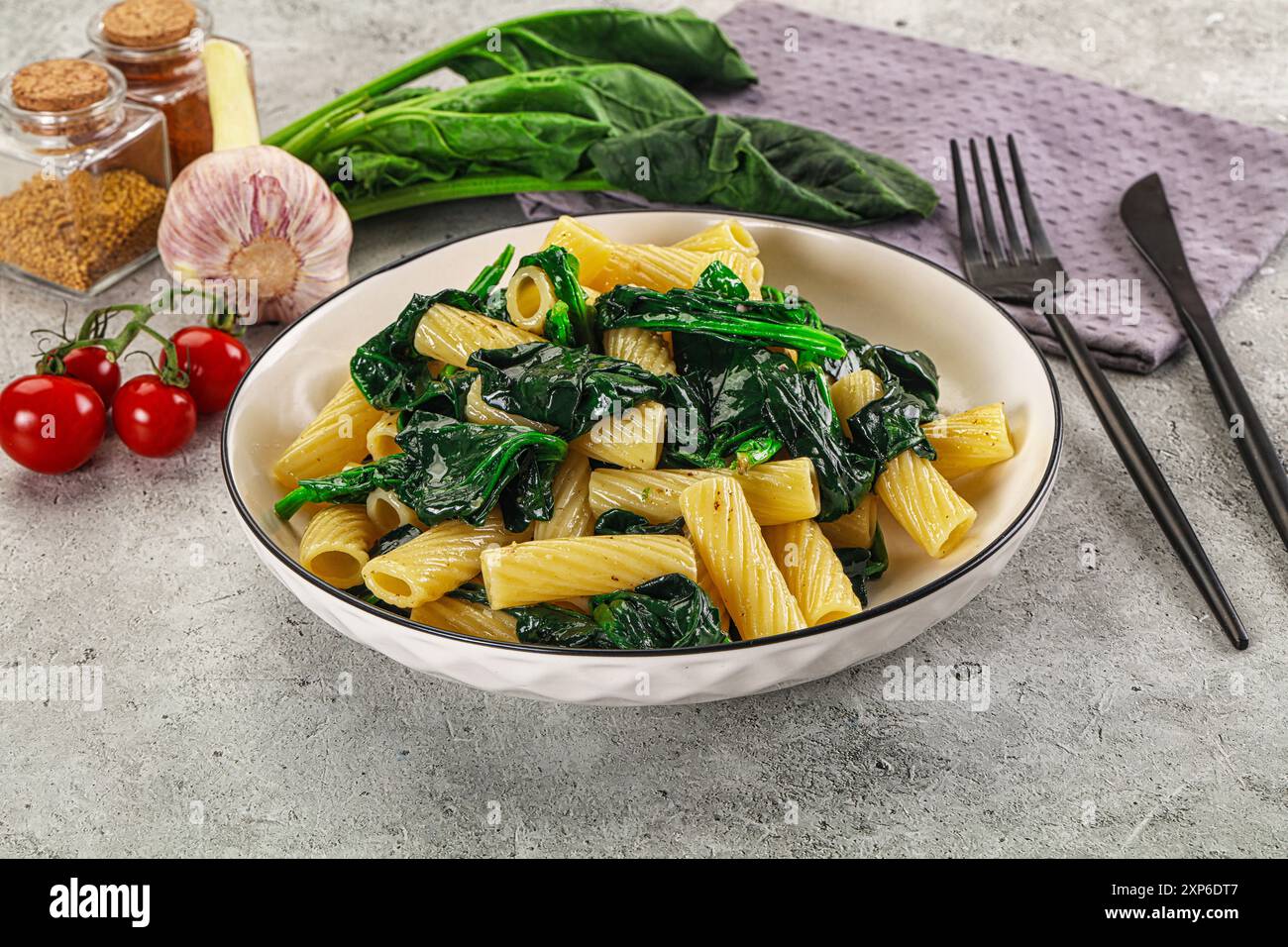 Italian cuisine - pasta tortiglioni with spinach Stock Photo - Alamy