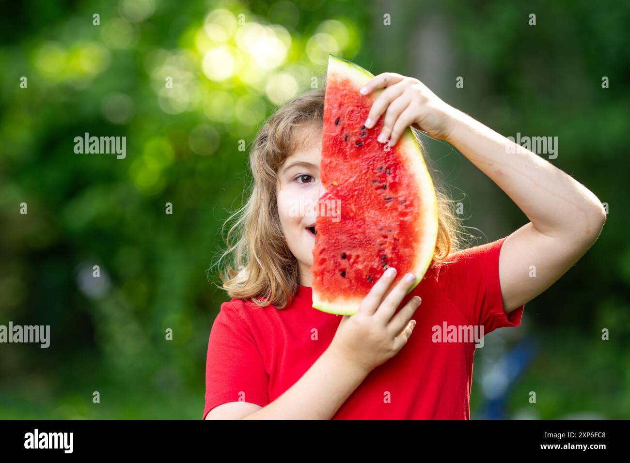 Kids face with watermelon, close up. Funny kid eating watermelon ...