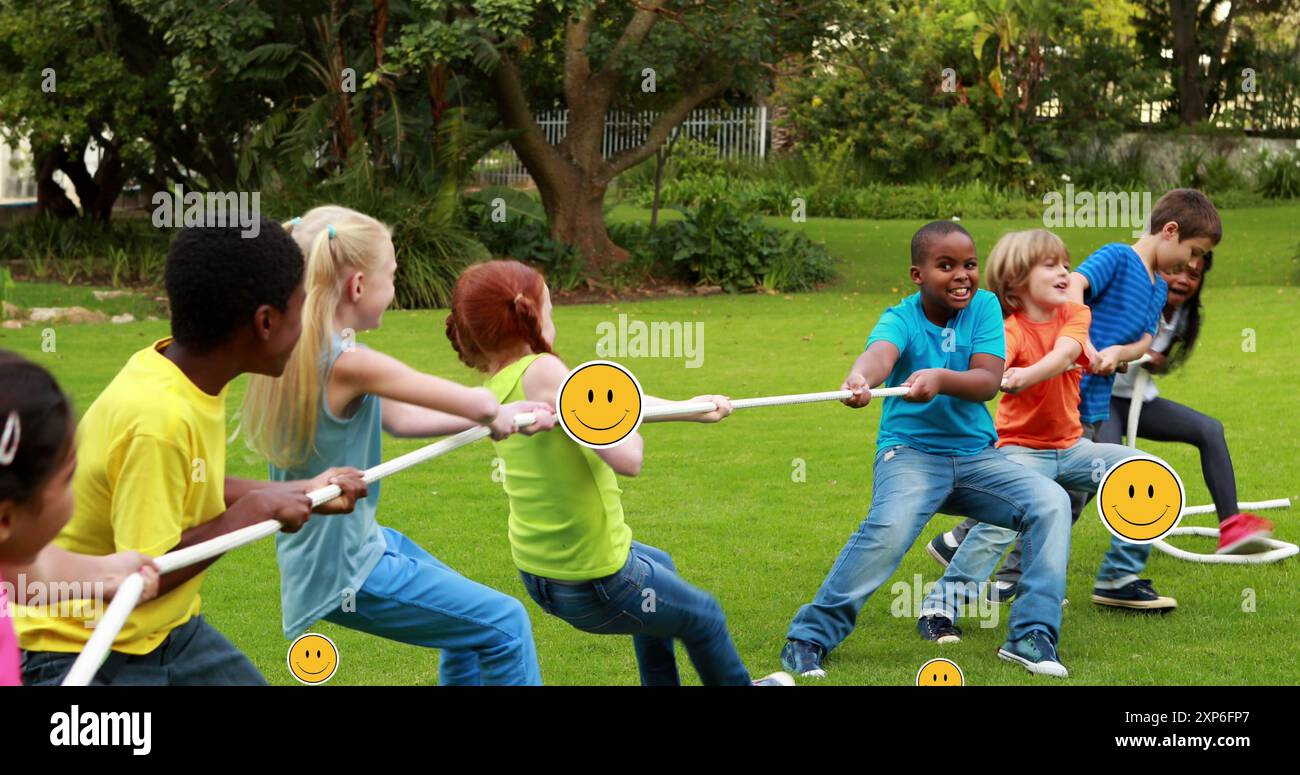 Image of falling icons over diverse school kids children pulling the ...