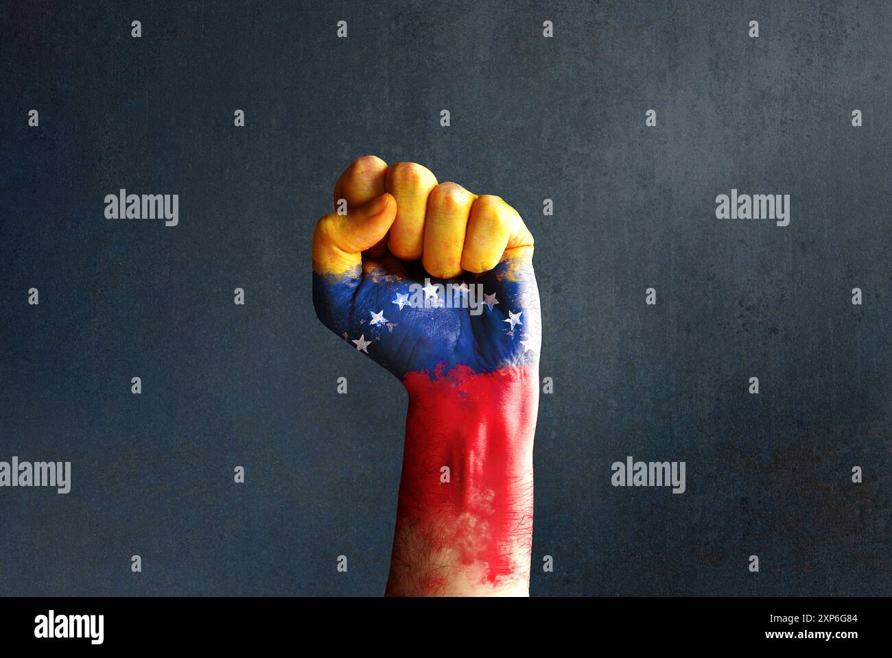 A raised fist painted with the Venezuelan flag symbolizes strength ...