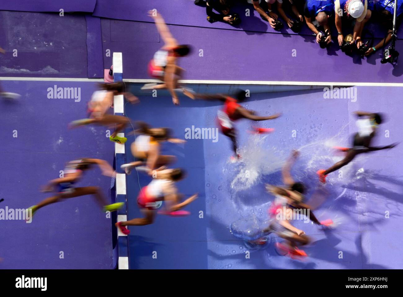 In this image taken with a slow shutter speed, athletes compete in a ...